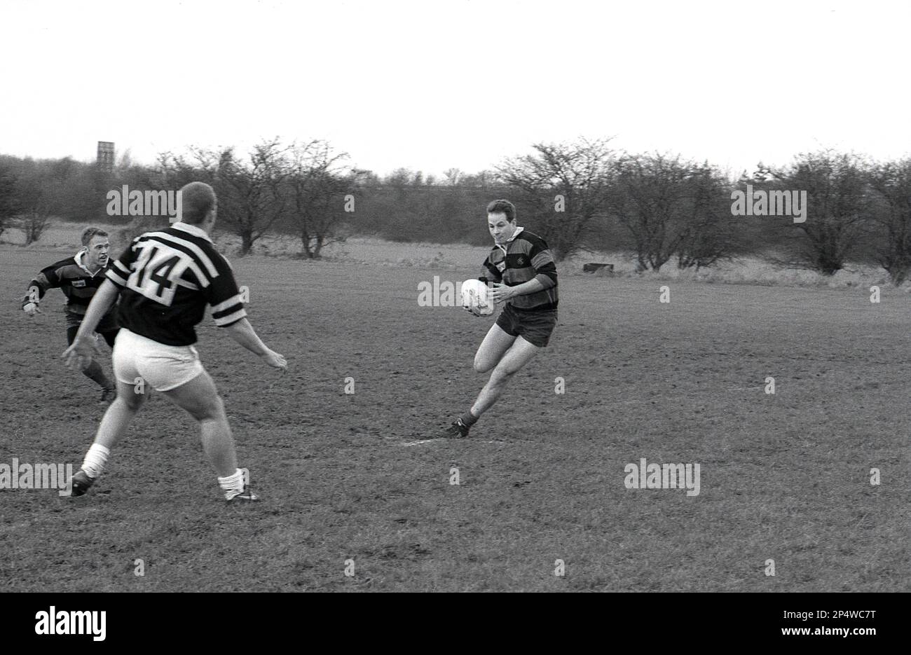 1980s, amateur rugby union, a winger with ball in hand ttrying to avoid ...
