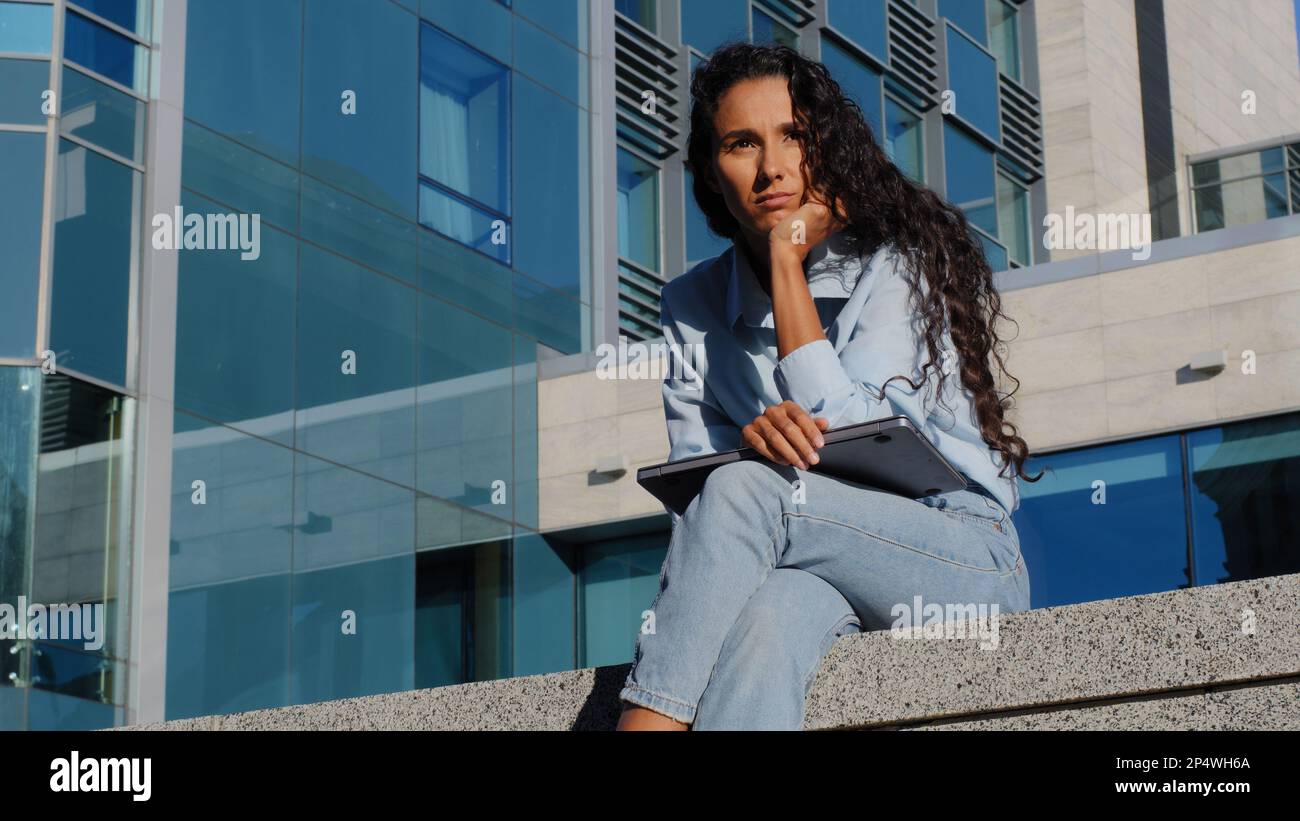 Portrait of business woman sad girl upset user sitting on building ...