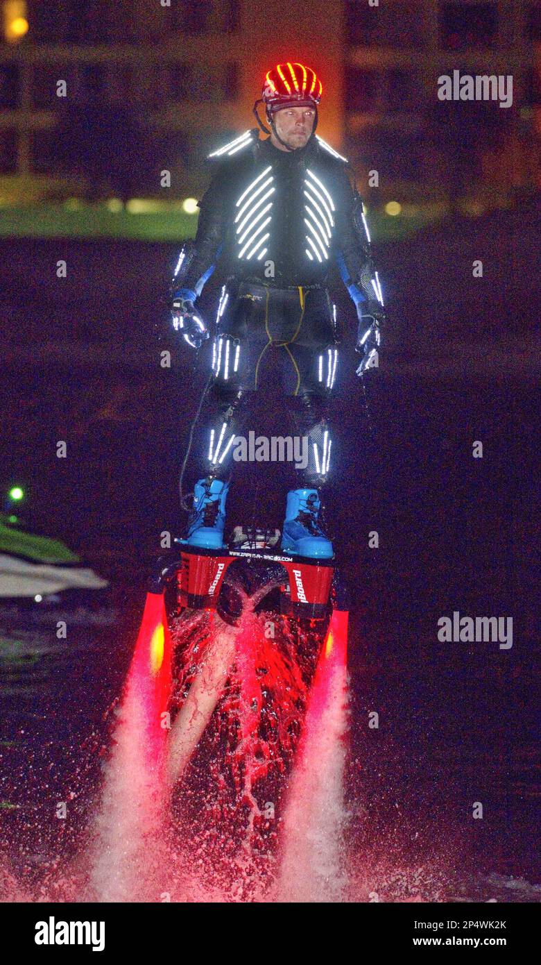 A man on a Flyboard makes his way along the parade route in the Destin ...
