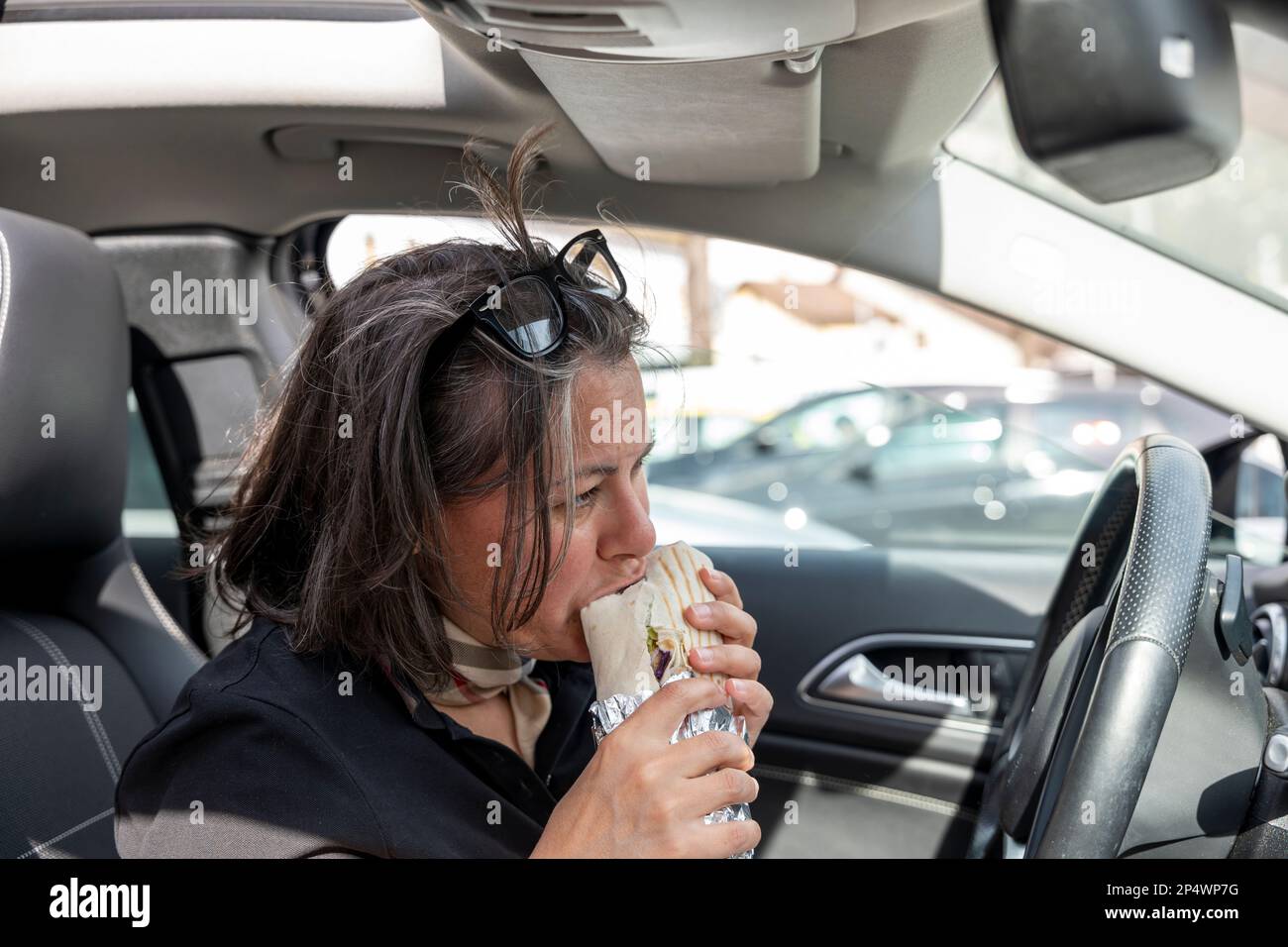 Elegant Woman Eating a Kebab in a Car in Switzerland Stock Photo - Alamy
