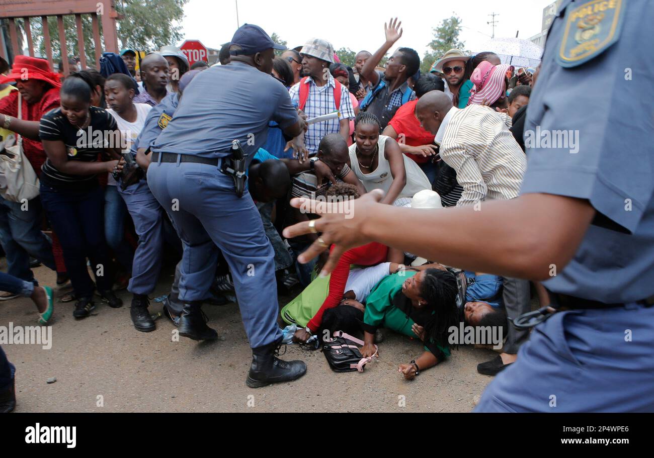 South African police control the crowd following a crush as people ...