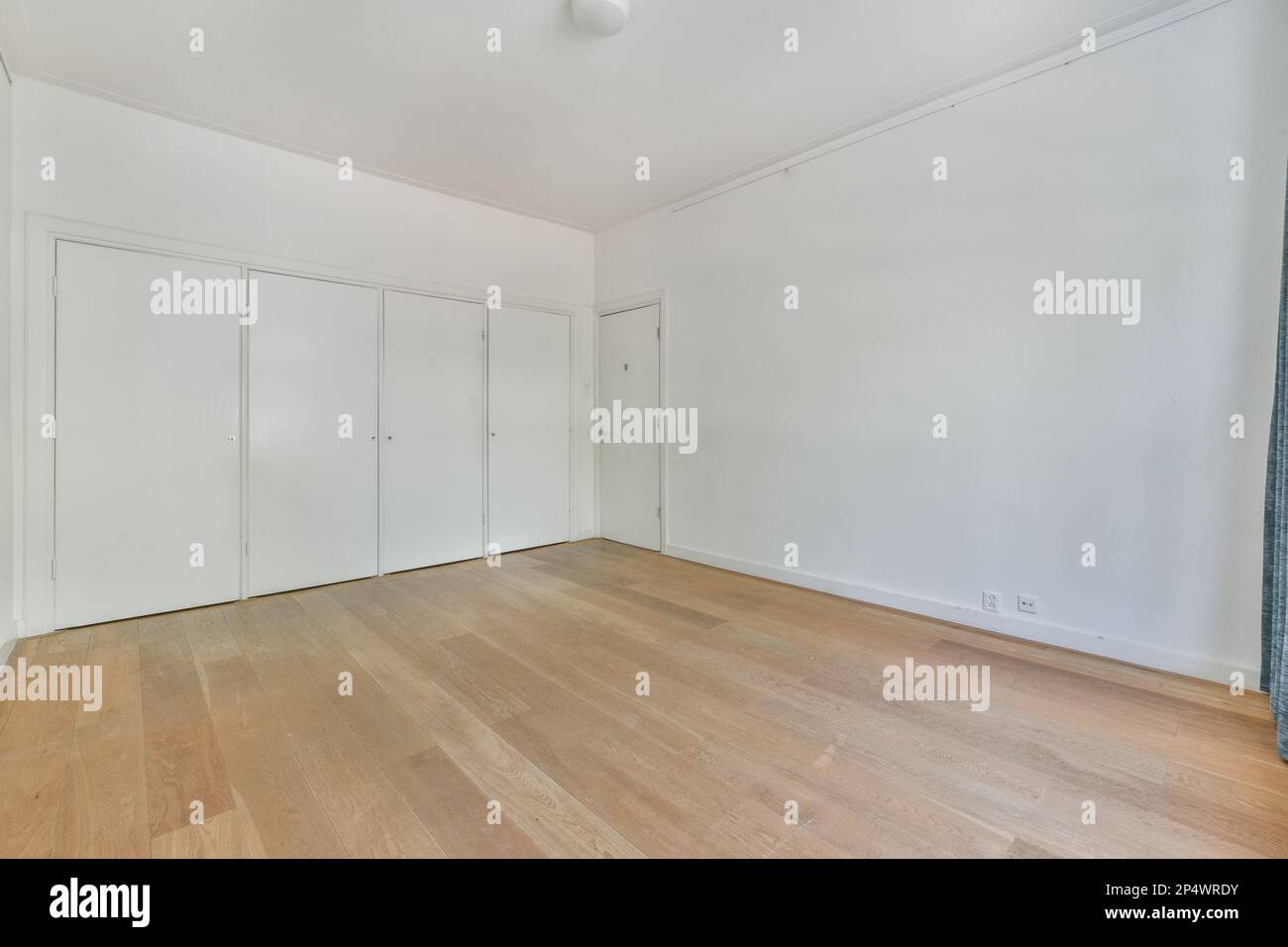 an empty room with white walls and wood flooring on one side, there is ...