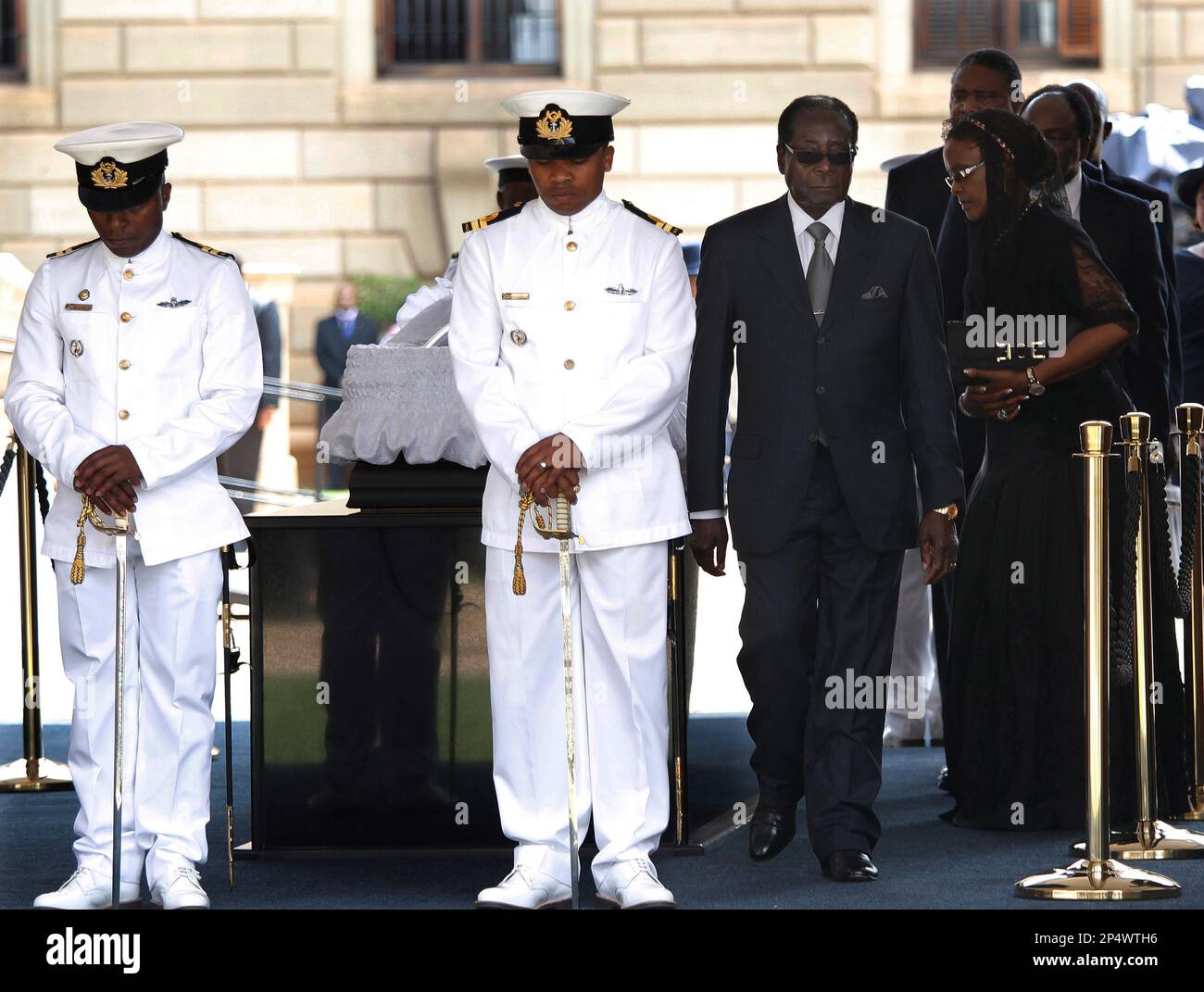 Zimbabwe President Robert Mugabe (2-R) and his wife Grace walk past the ...