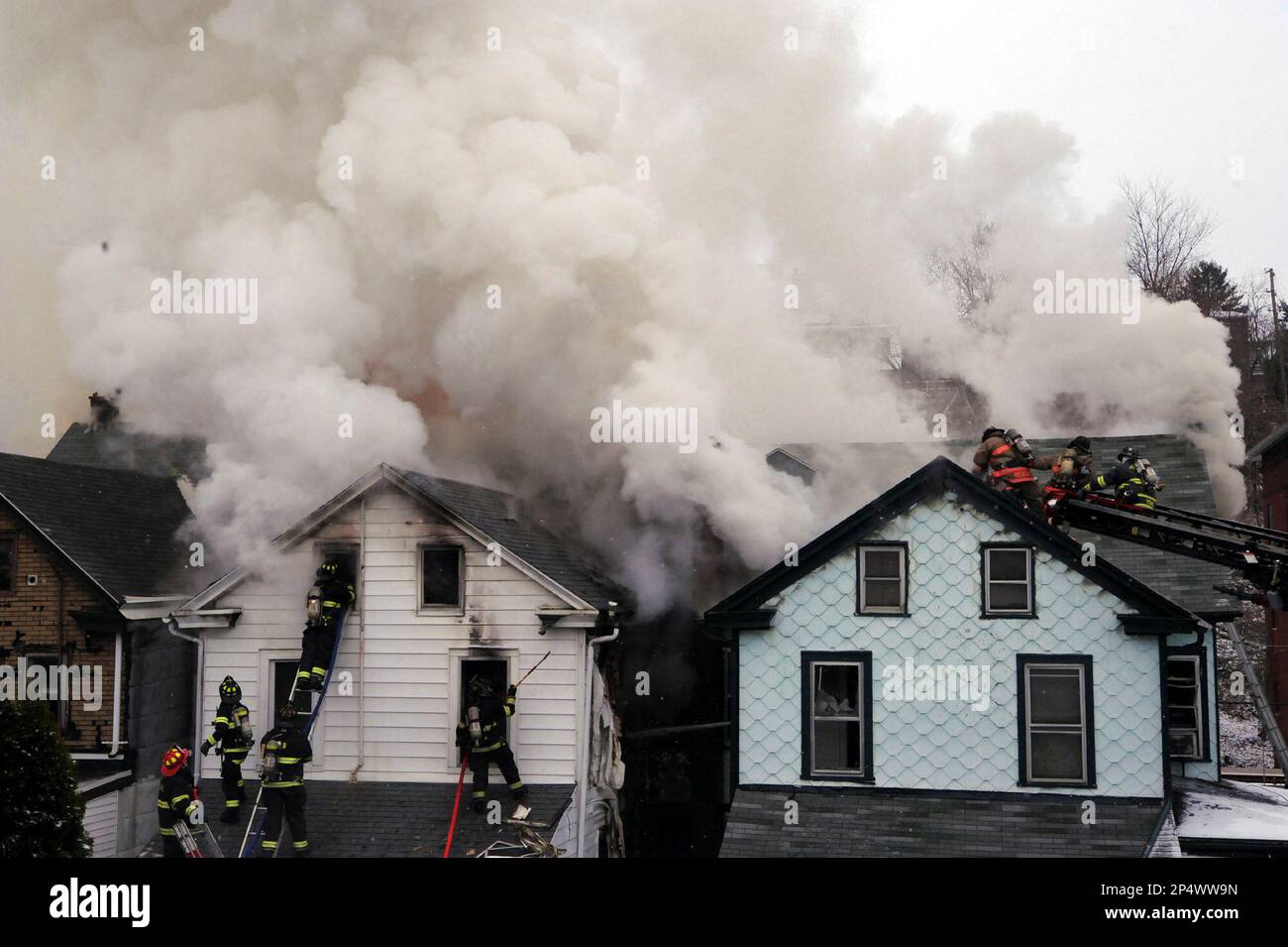 Smoke billows from the front of the homes on South Rock Street in ...