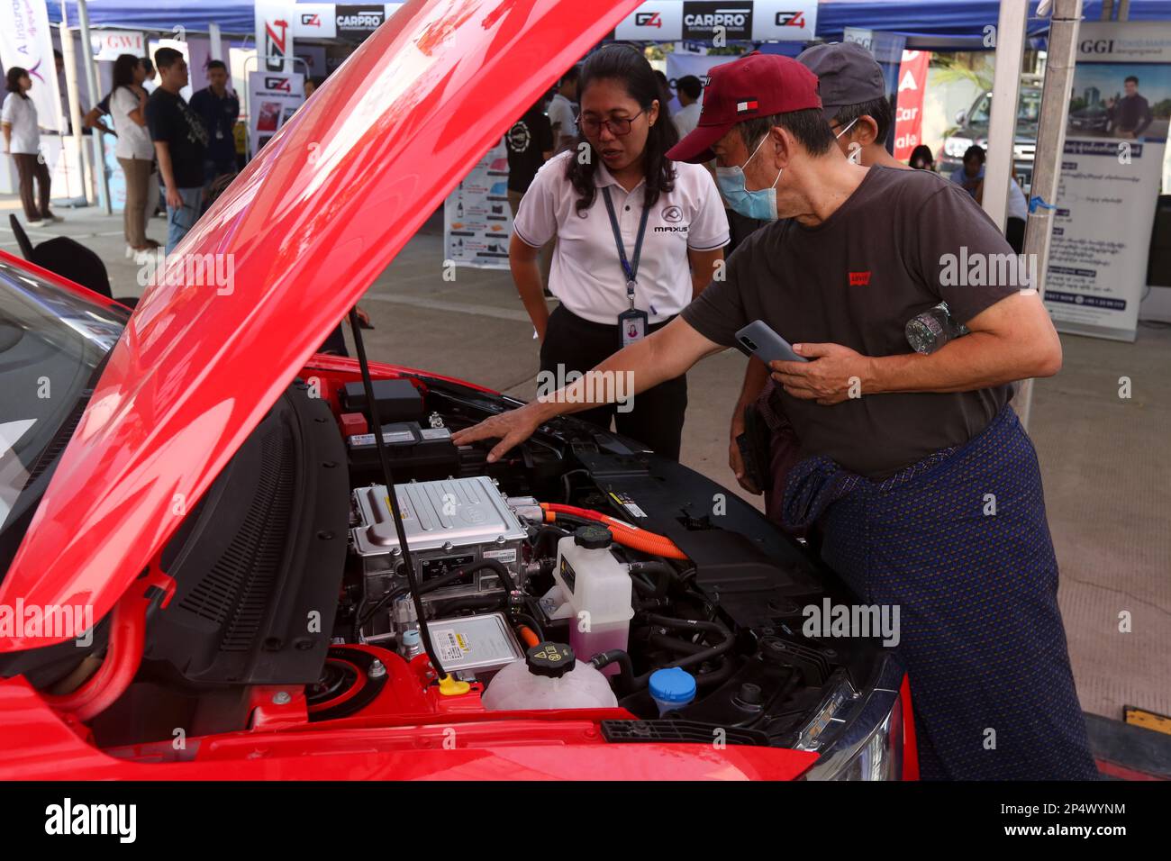 Yangon, Myanmar. 2nd Mar, 2023. Visitors look at a BYD e2 battery ...