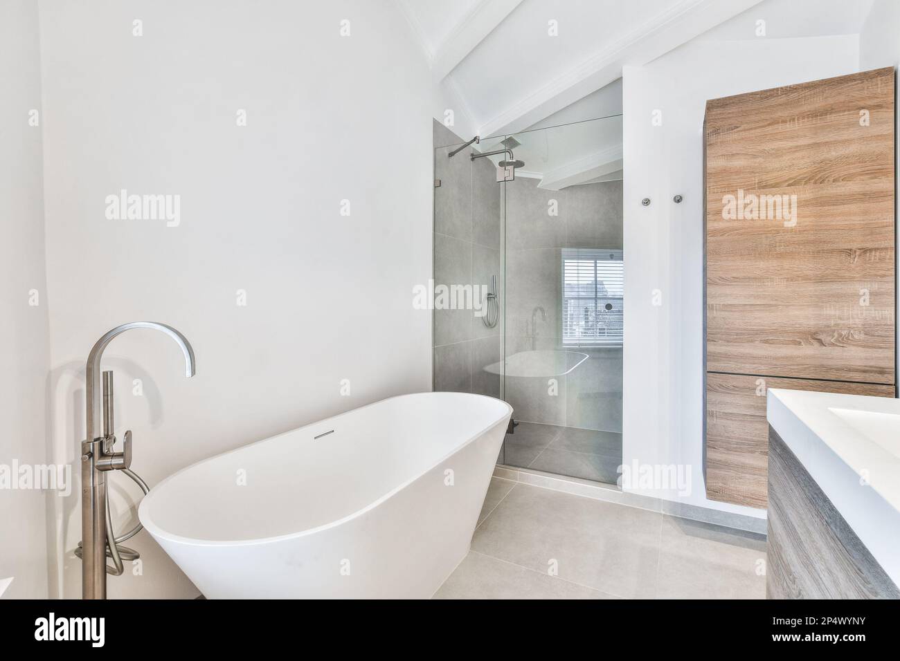 a bathroom with a large bathtub and wooden paneled wall behind the tub ...