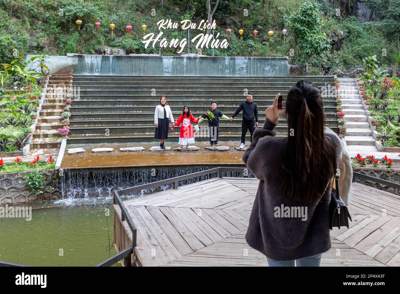A family posing for a photograph at Ninh Xuan, Vietnam Stock Photo - Alamy