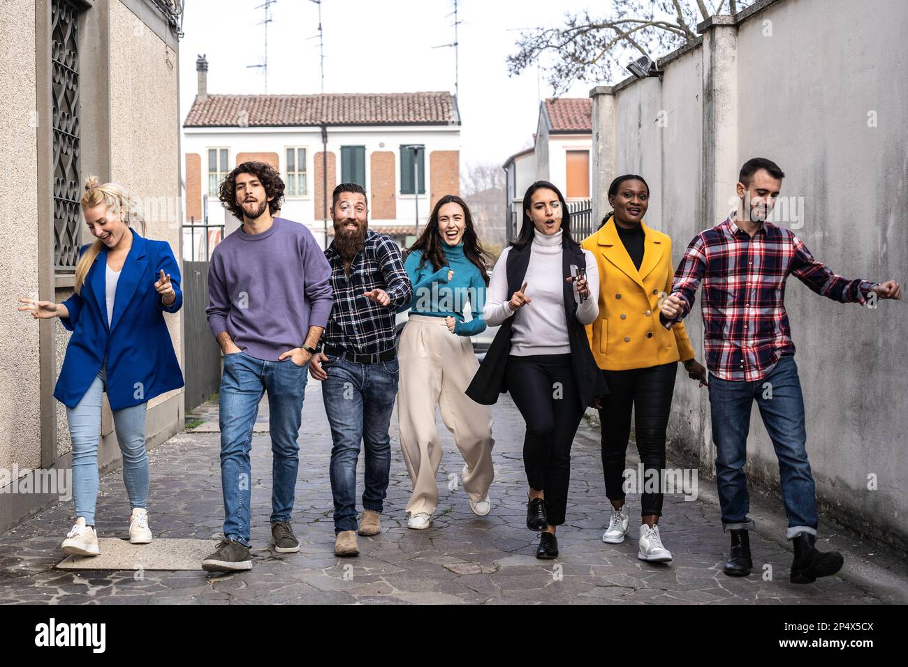 Happy urban friends walking at old town acting crazy funny movies ...