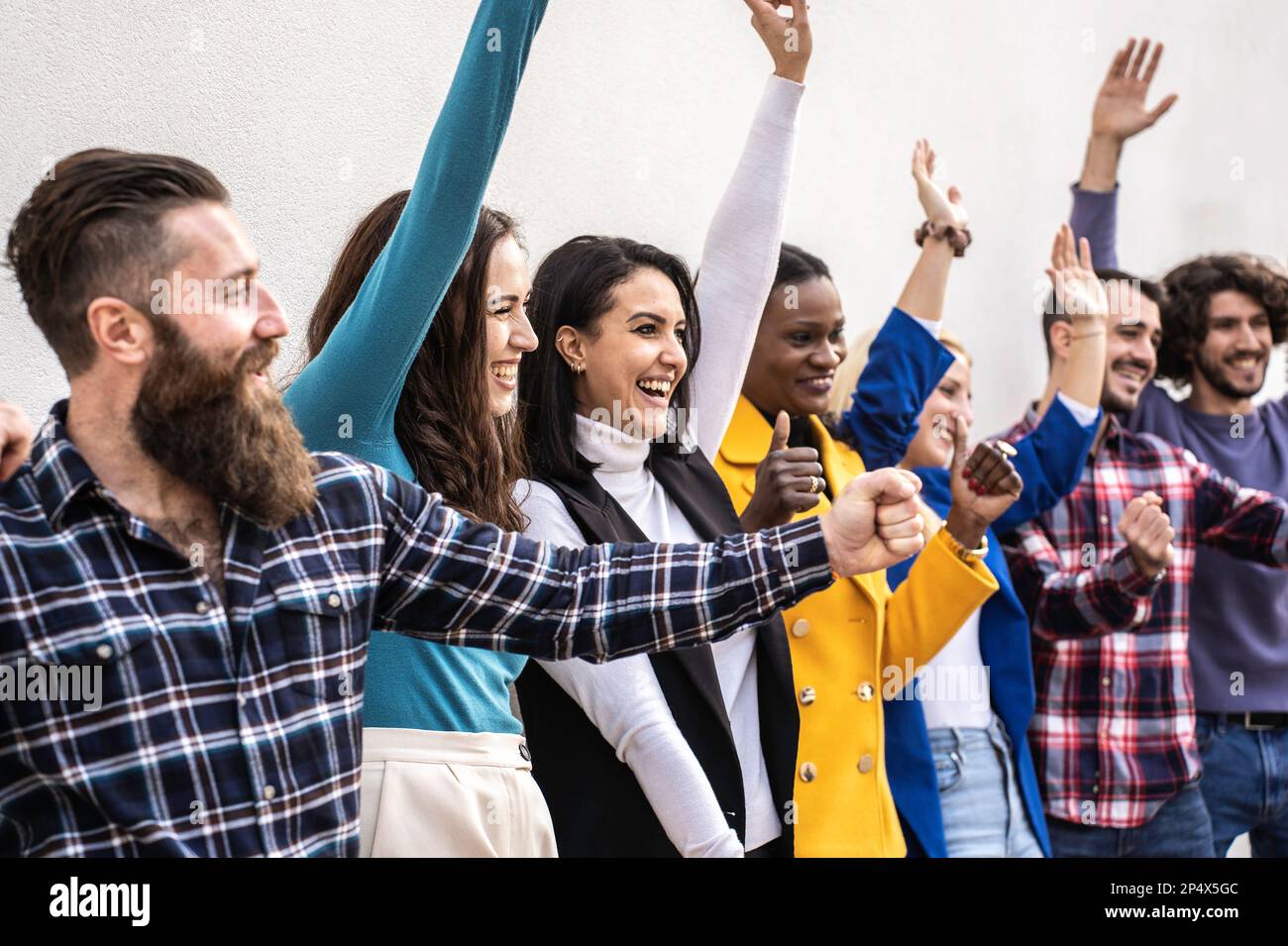 Multi ethnic guys and girls having fun outdoors with the thumb raised ...