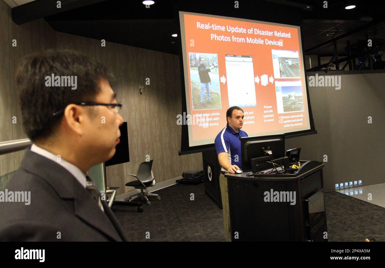 Dr. Ge Jin, left listens Wednesday morning while Jack Moreland talks ...