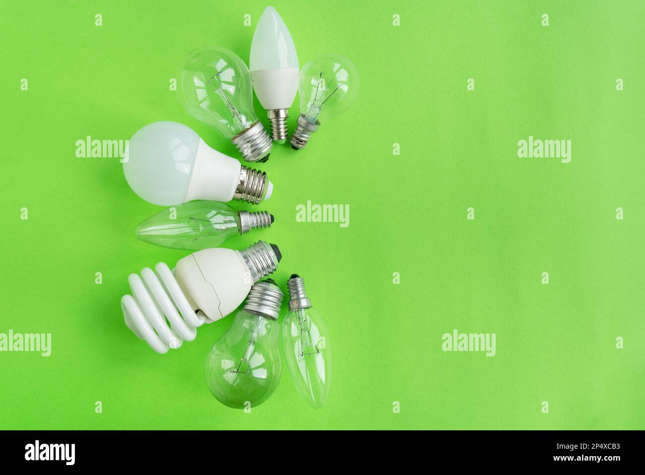 A set of different types of LED lamps isolated on a green background ...