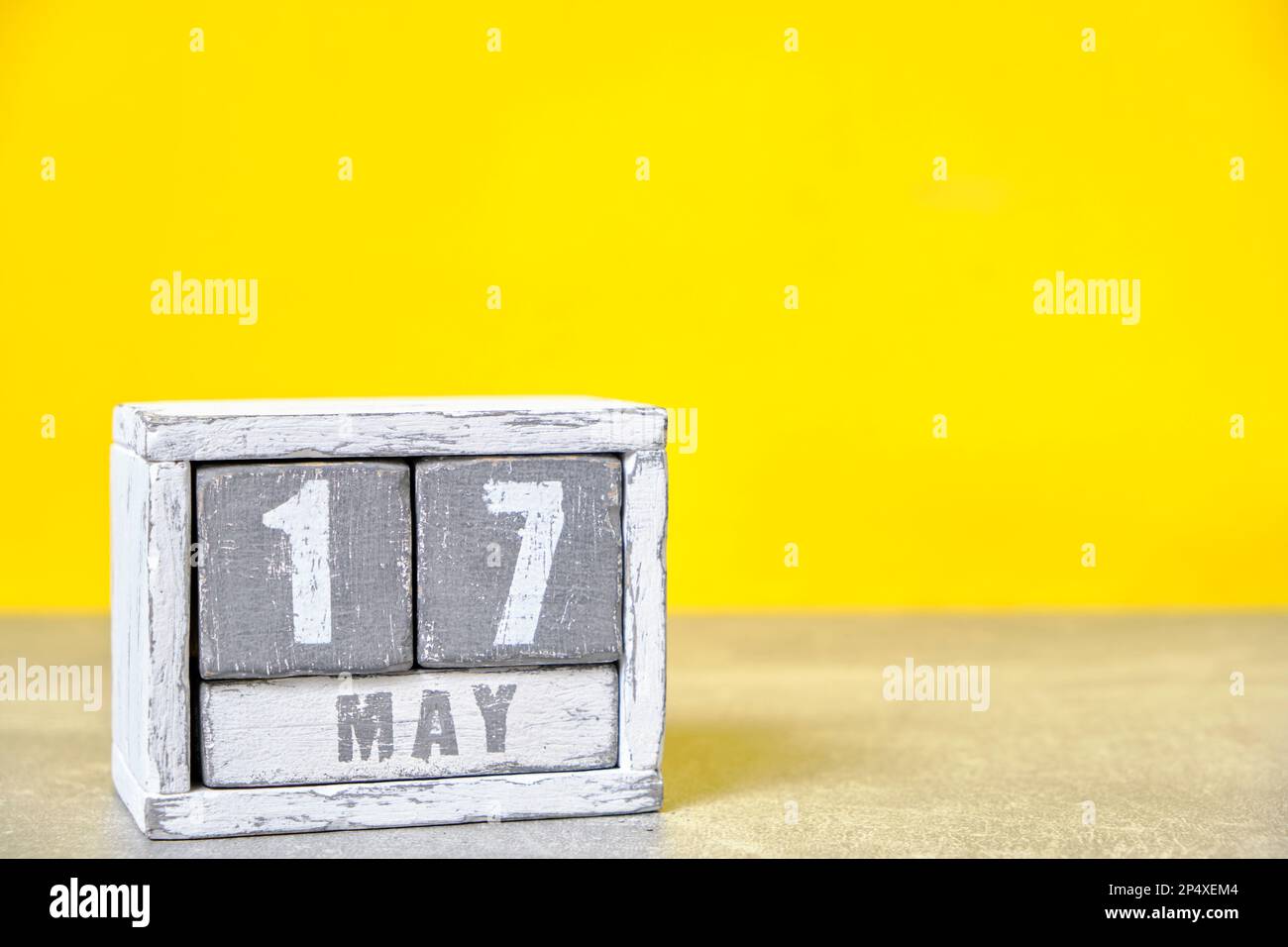 May 17 calendar made wooden cubes yellow background.With an empty space ...