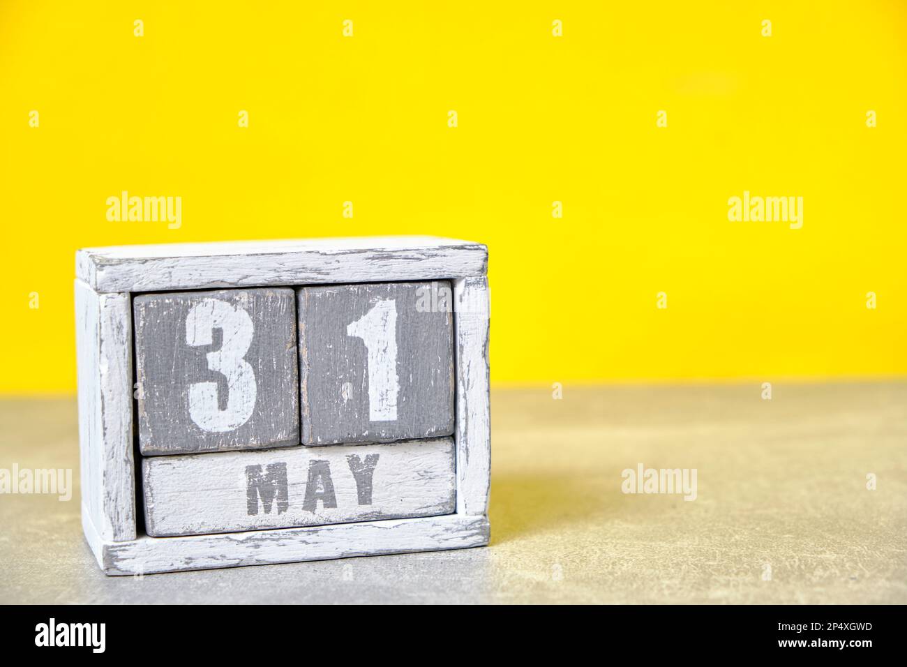 May 31 calendar made wooden cubes yellow background.With an empty space ...