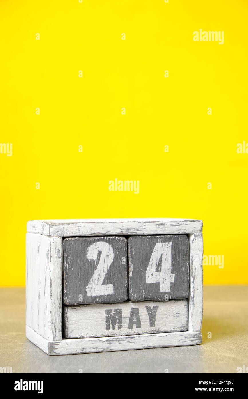 May 24 calendar made wooden cubes yellow background.With an empty space ...