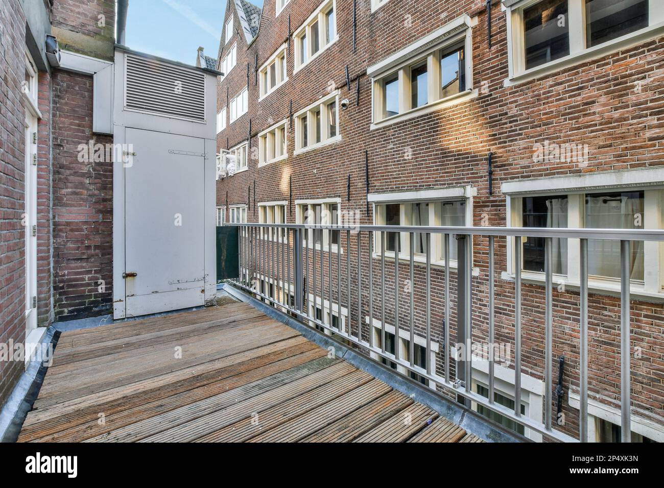 an outside area with wooden flooring and brick buildings in the ...