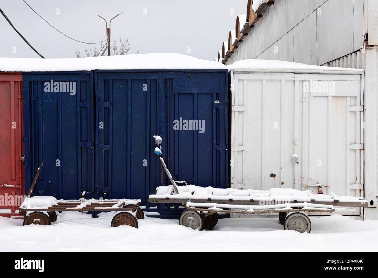 a trolley for transporting goods stands on the street. market container ...