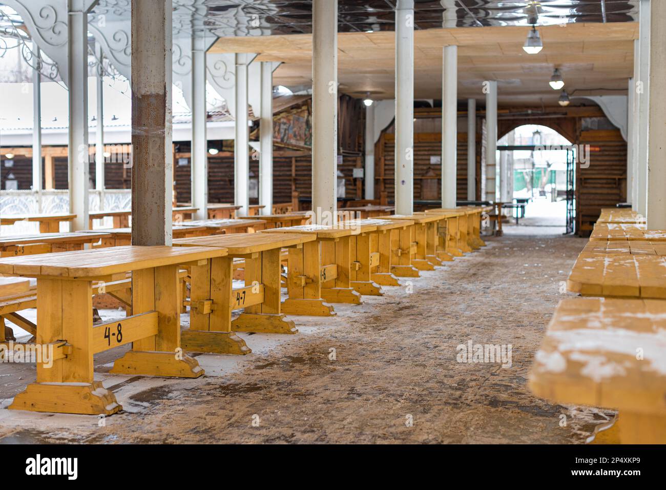 wooden tables stand in a row outdoors. wooden tables stand in a row ...