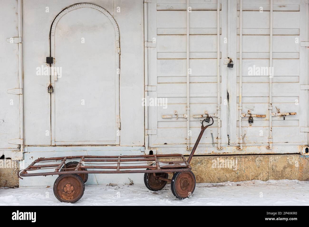 a trolley for transporting goods stands on the street. trolley for ...