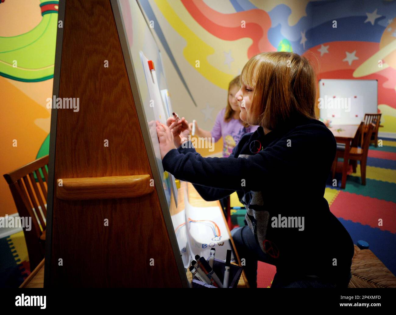 Lexi Murophy, 7, right, and her sister Autumn Murphy, 8, work on ...