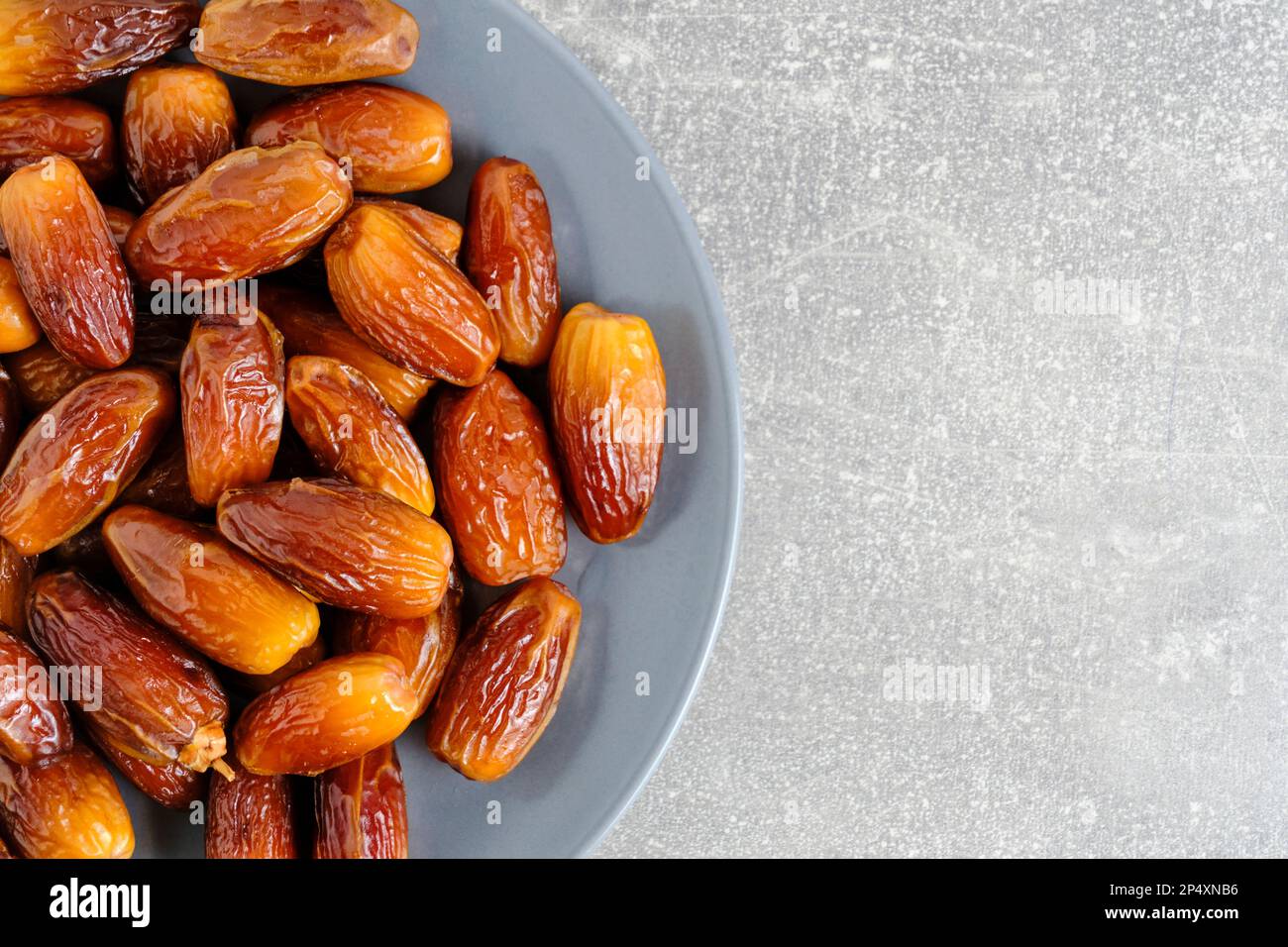 Dates plate gray background.Edible fruits date palm Stock Photo - Alamy
