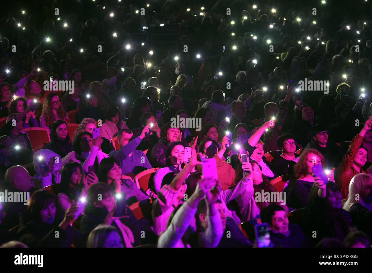 IVANO-FRANKIVSK, UKRAINE - MARCH 3, 2023 - Spectators hold their ...