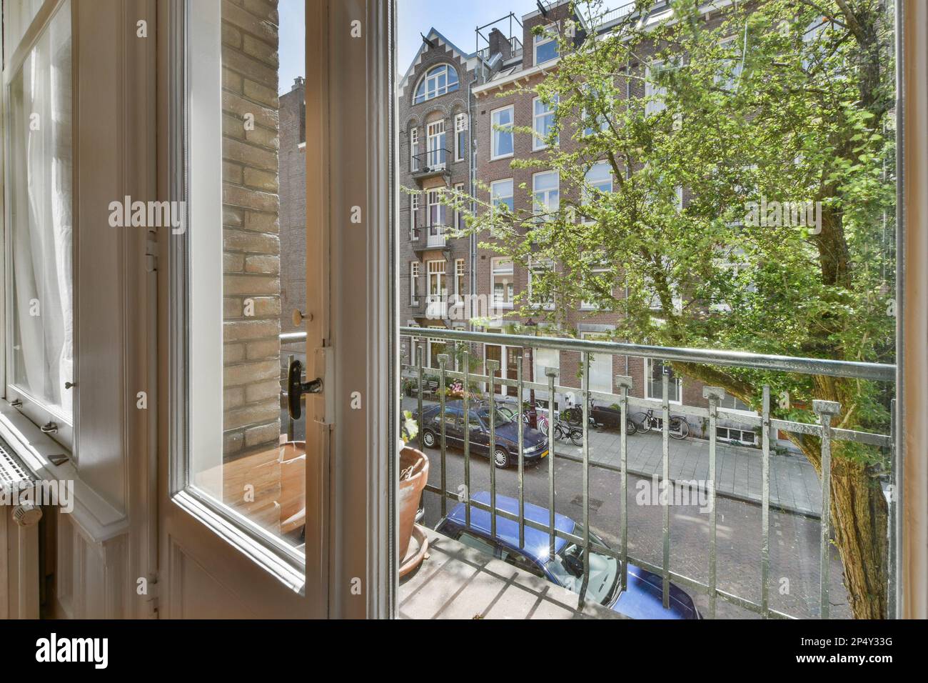 an outside view from inside a window in a room with white walls and ...