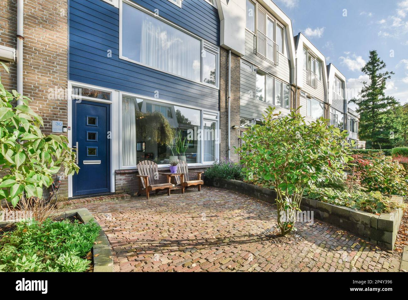 Amsterdam, Netherlands - 10 April, 2021: a brick patio with chairs and ...