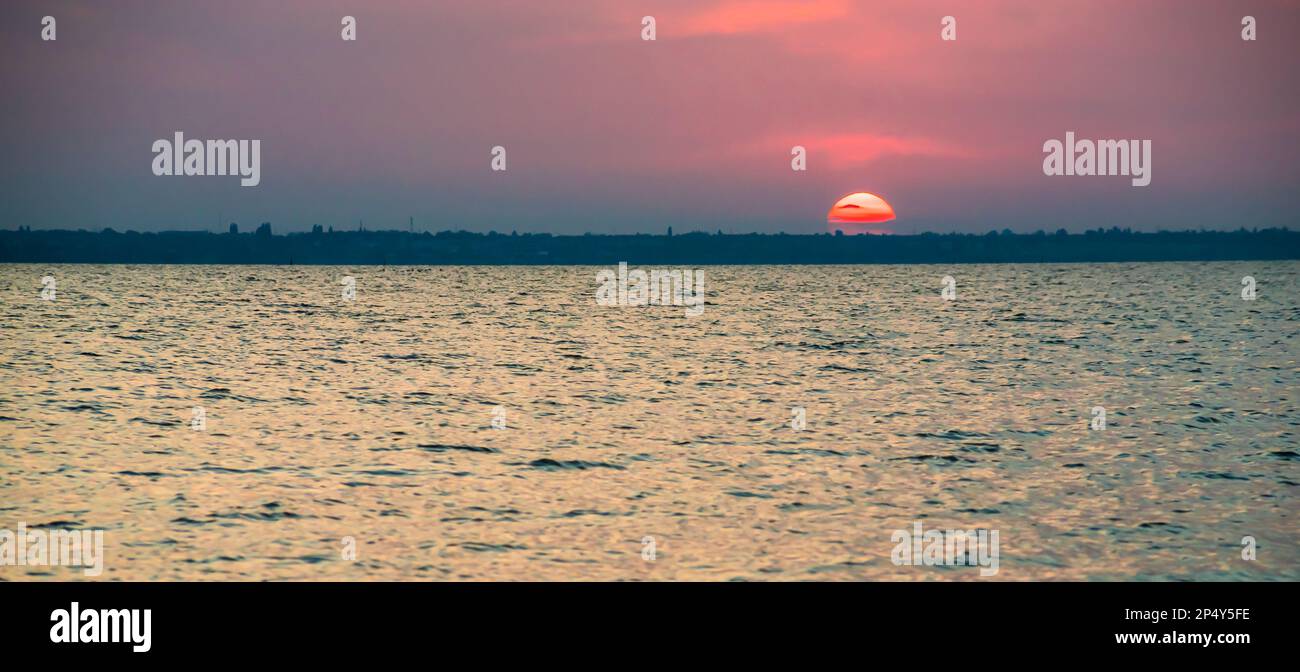 Beautiful red and orang sunset over the lake Stock Photo - Alamy