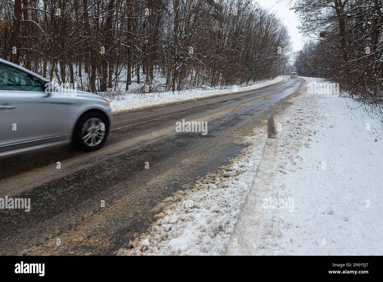 driving in winter after a snowfall, ice on the road, temperatures below ...
