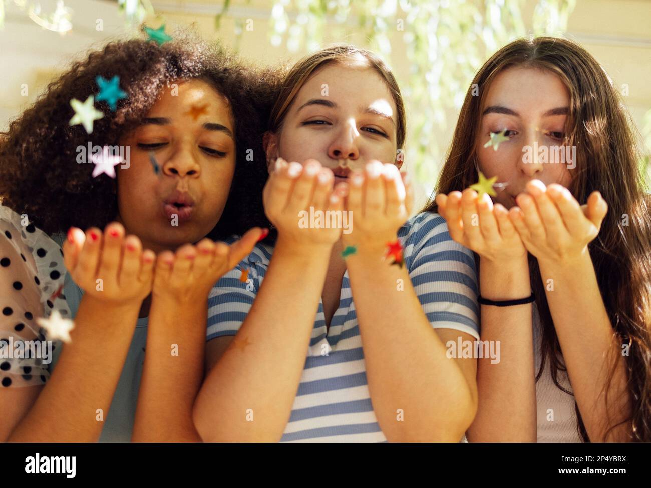 Close up of three cute happy teenage girls of different nationalities ...