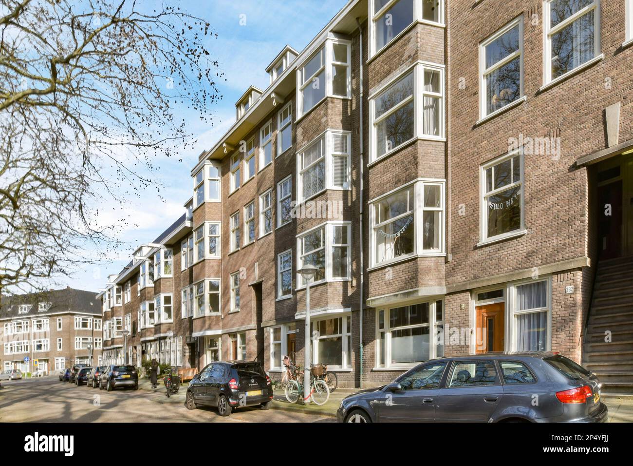 a street with cars parked on the side and buildings in the back ground ...