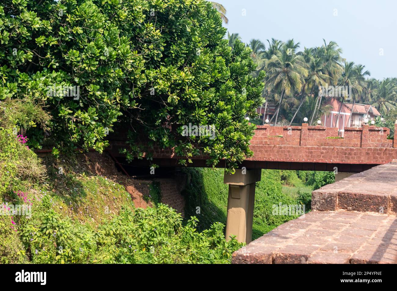 Candolim, Goa, India - January 2023: A laterite brick bridge across a ...