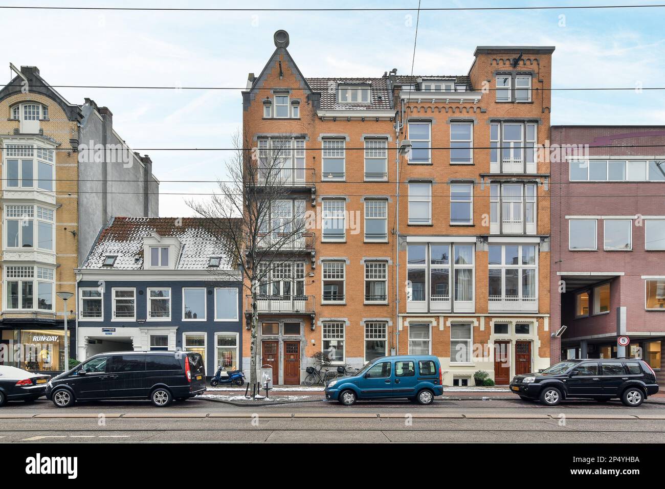 some buildings and cars parked on the side of the street in front of ...