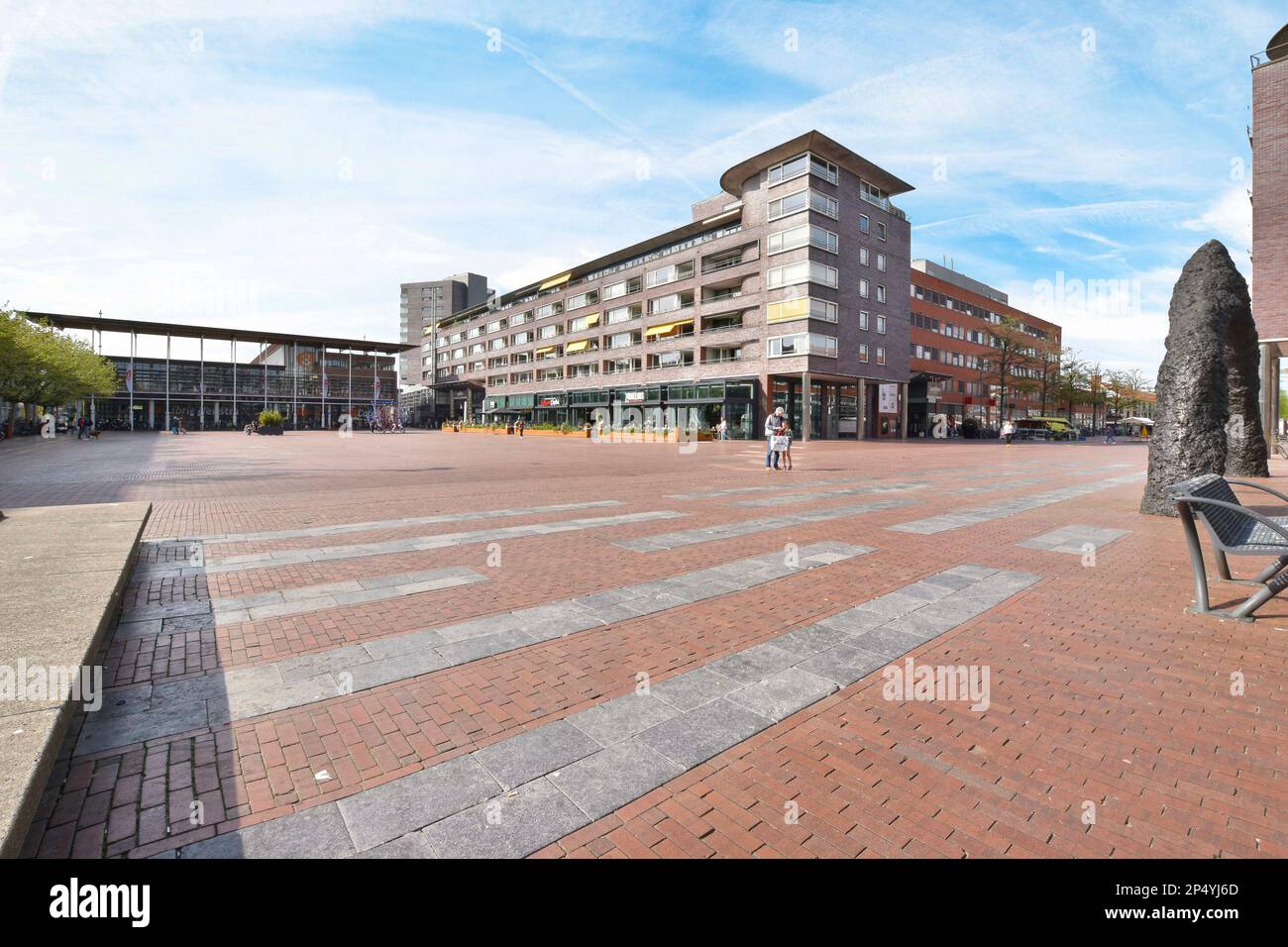 an empty city square in the middle of town, with people walking around ...
