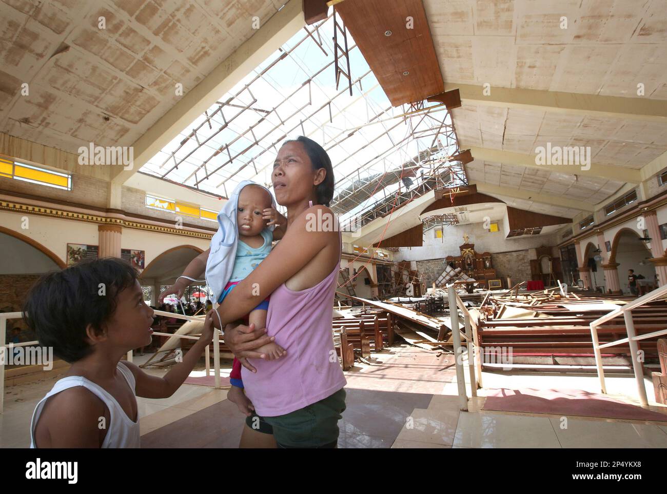 Survivors evauate at a church, whose roofs have been blown off in Bogo ...