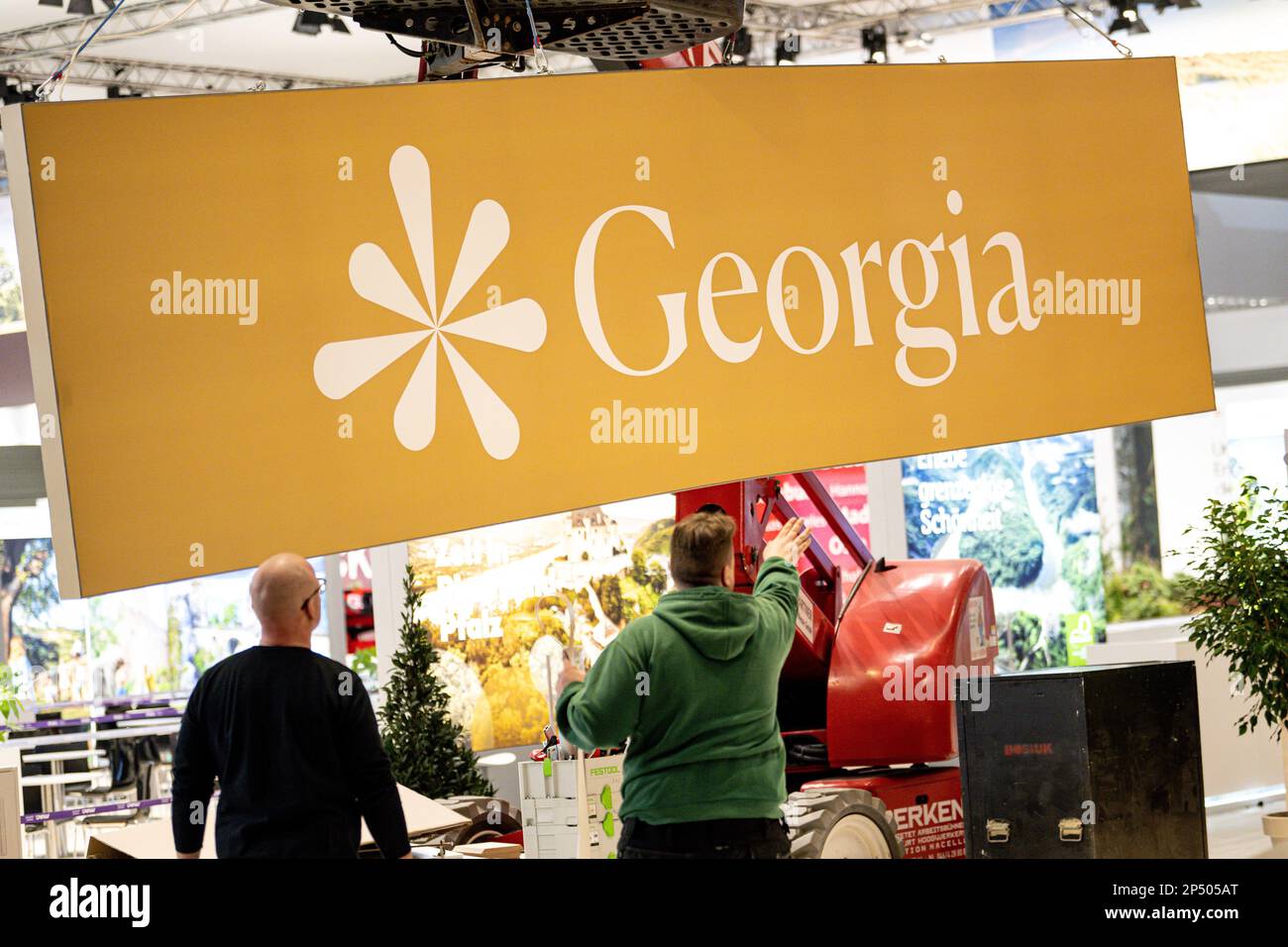Berlin, Germany. 06th Mar, 2023. Two men work at the stand for Georgia ...