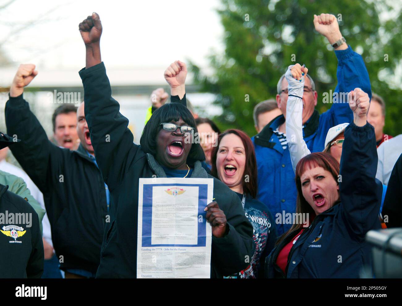 Machinist Stephanie Lloyd-Agnew holds up a contract while chanting ...