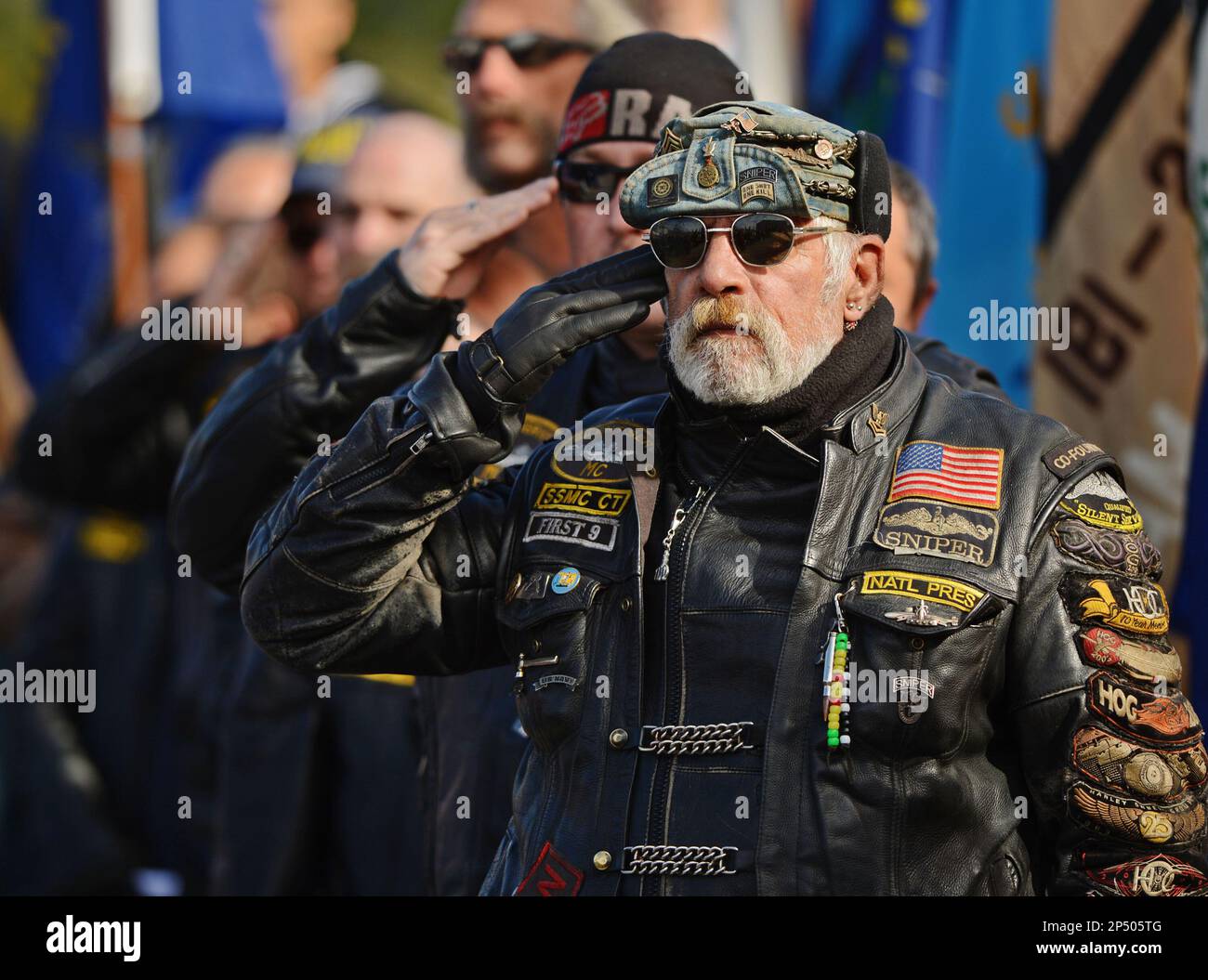 Members of the Silent Service Motorcycle Club salute during the ...
