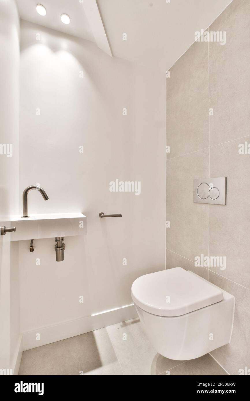 a bathroom with a white toilet and light fixtures on the wall in front ...