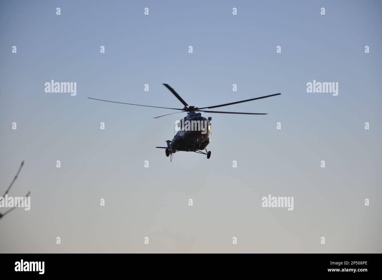 Military helicopter maneuvers in the blue sky. Air force Mil Mi-171Sh ...