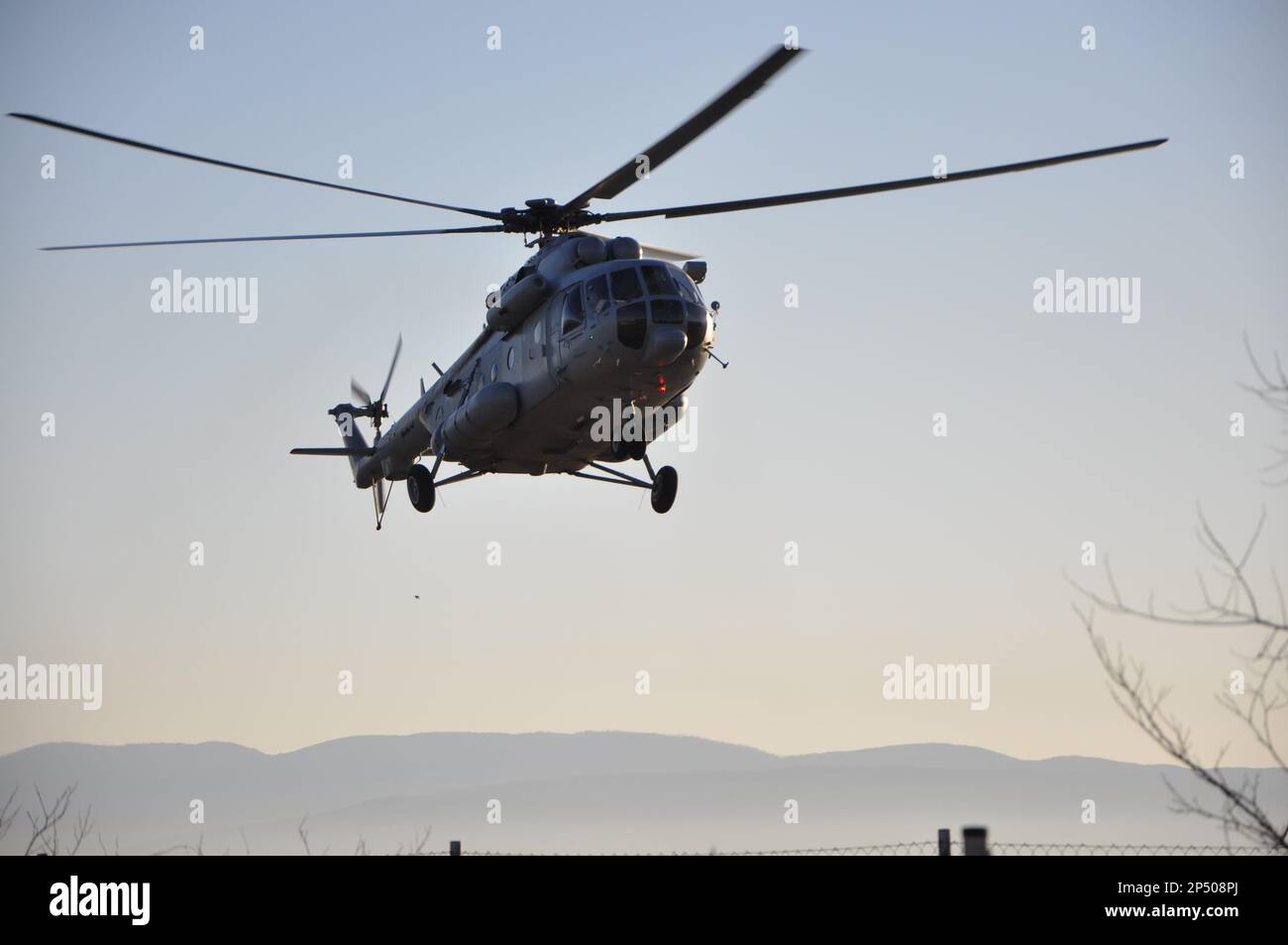 Military helicopter maneuvers in the blue sky. Air force Mil Mi-171Sh ...