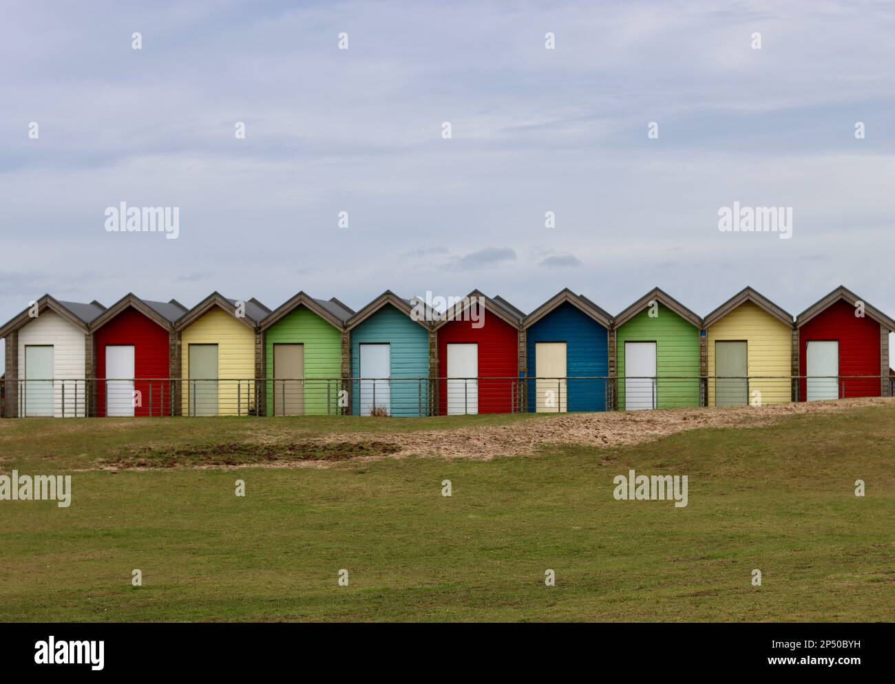 Line of colourful wooden beach huts Stock Photo - Alamy