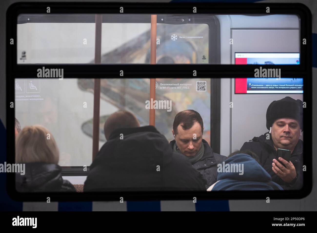 An image of a fish decorating the wall is seen through windows of a ...
