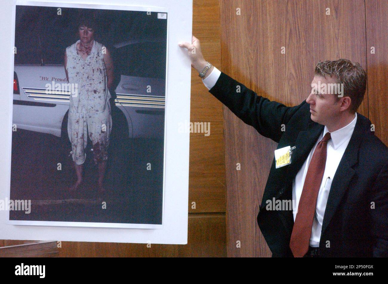 First Assistant District Attorney Brett Harrison holds up a crime scene ...
