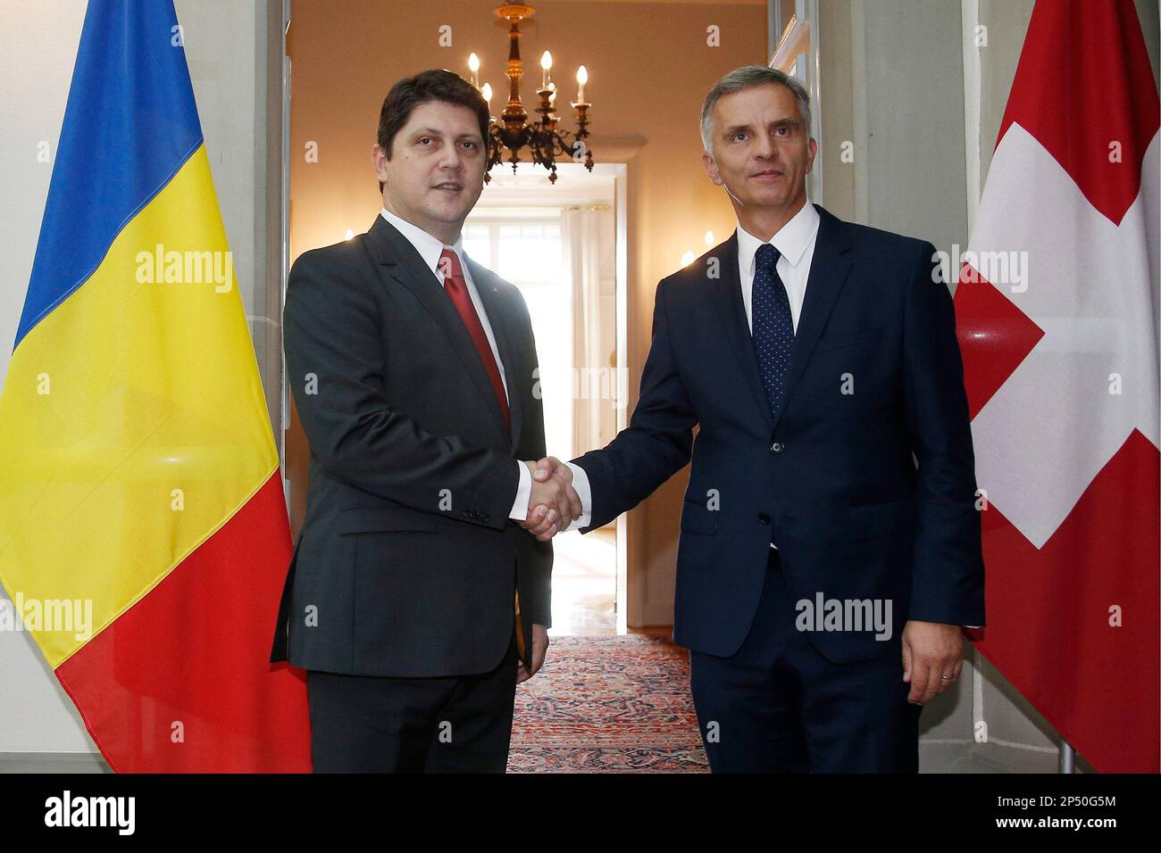 Swiss Foreign Minister Didier Burkhalter, right, shakes hands with ...