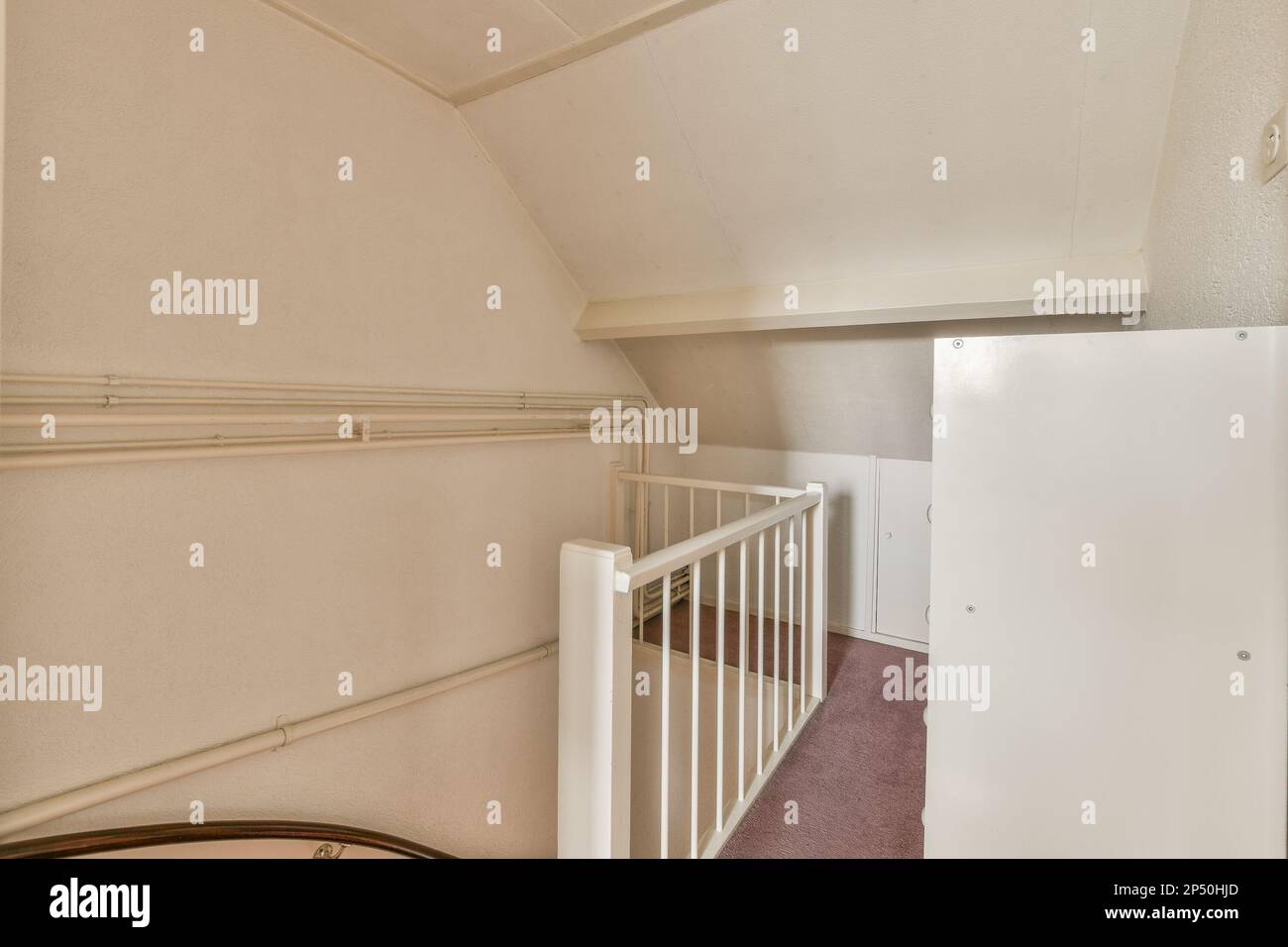 an empty room with white walls and purple carpeted stairs leading up to ...