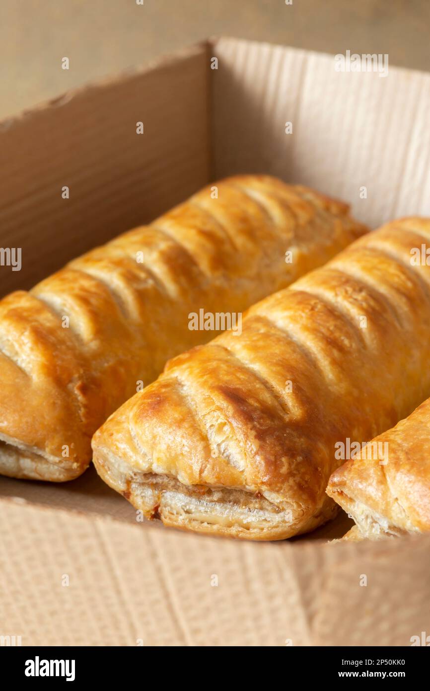 Sausage rolls in a cardboard takeaway tray. Sustainable biodegradable ...