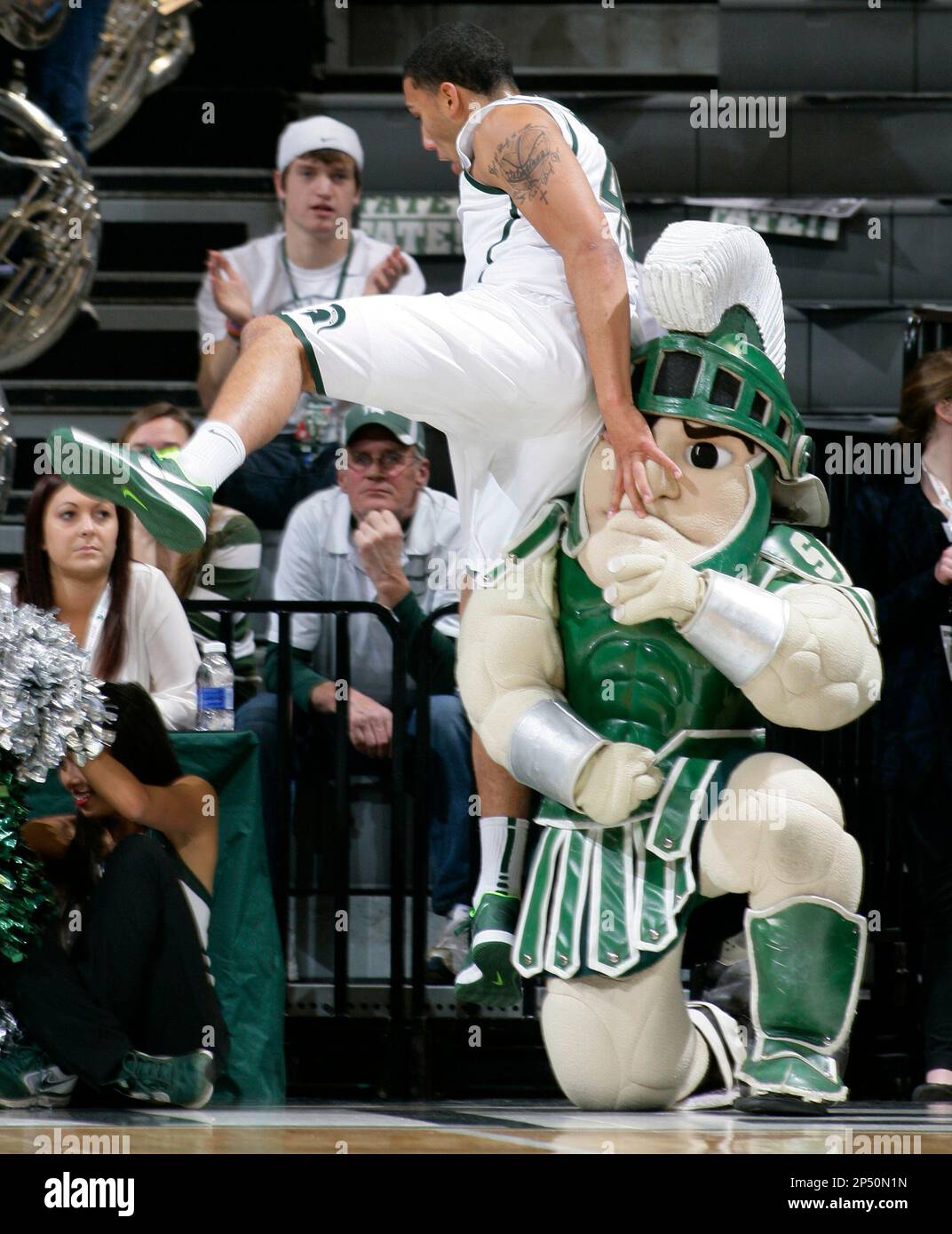 Michigan State's Denzel Valentine collides with the Michigan State ...