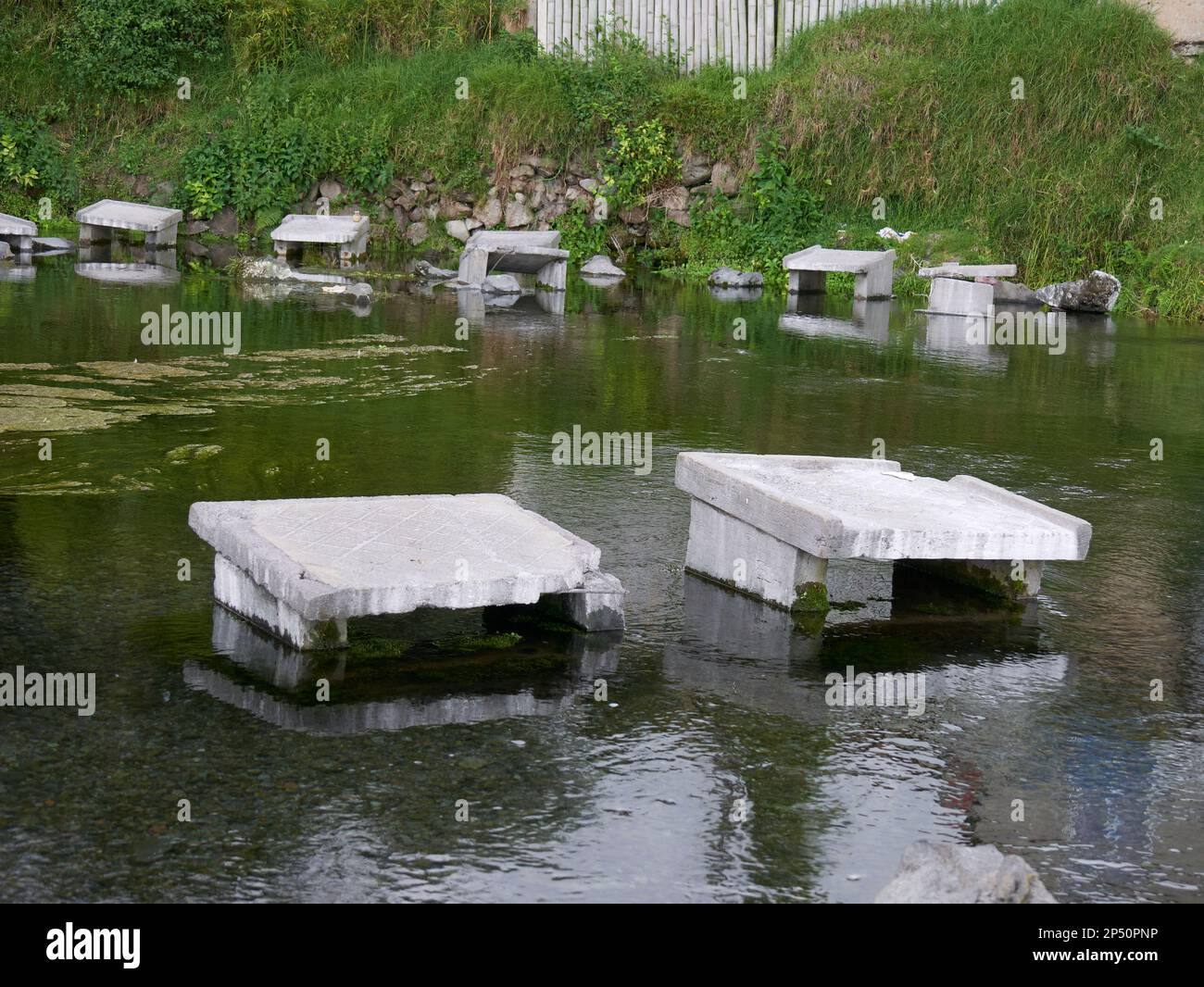 Washing in the Wild: Public Laundry Facilities in a River Stock Photo ...