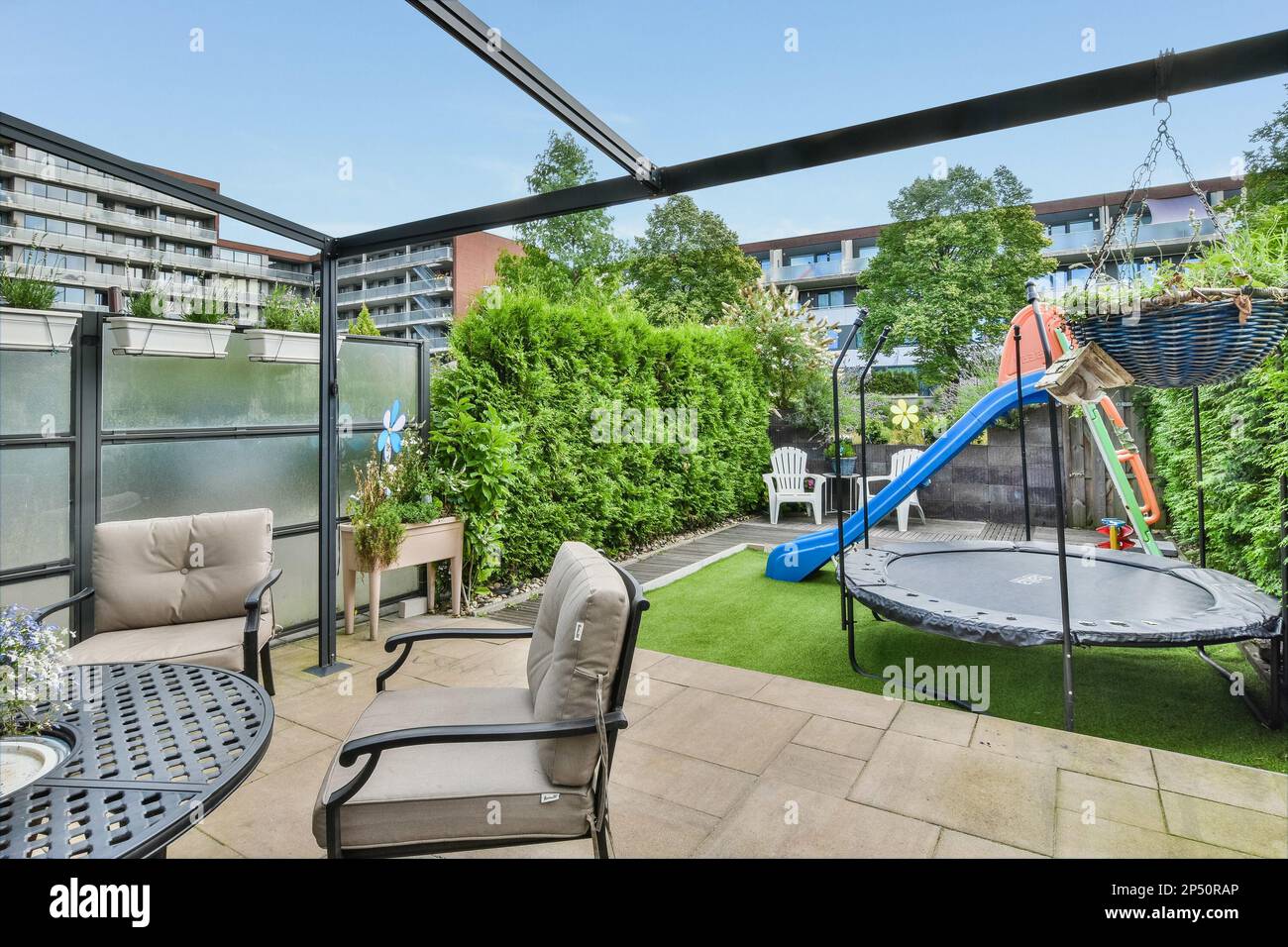 Amsterdam, Netherlands - 10 April, 2021: a backyard area with a swing ...